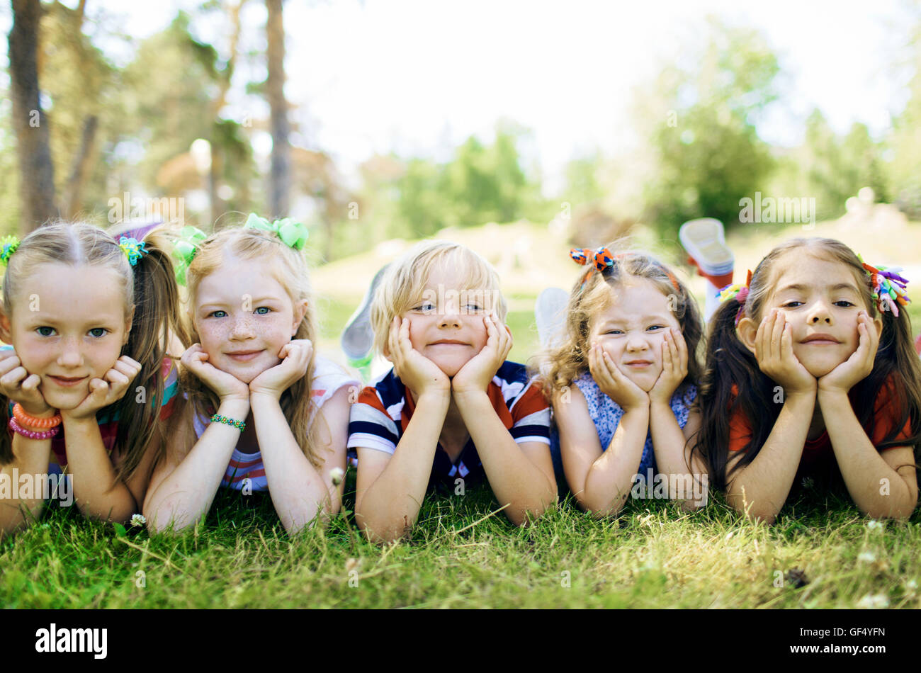 Kids on grass Stock Photo - Alamy