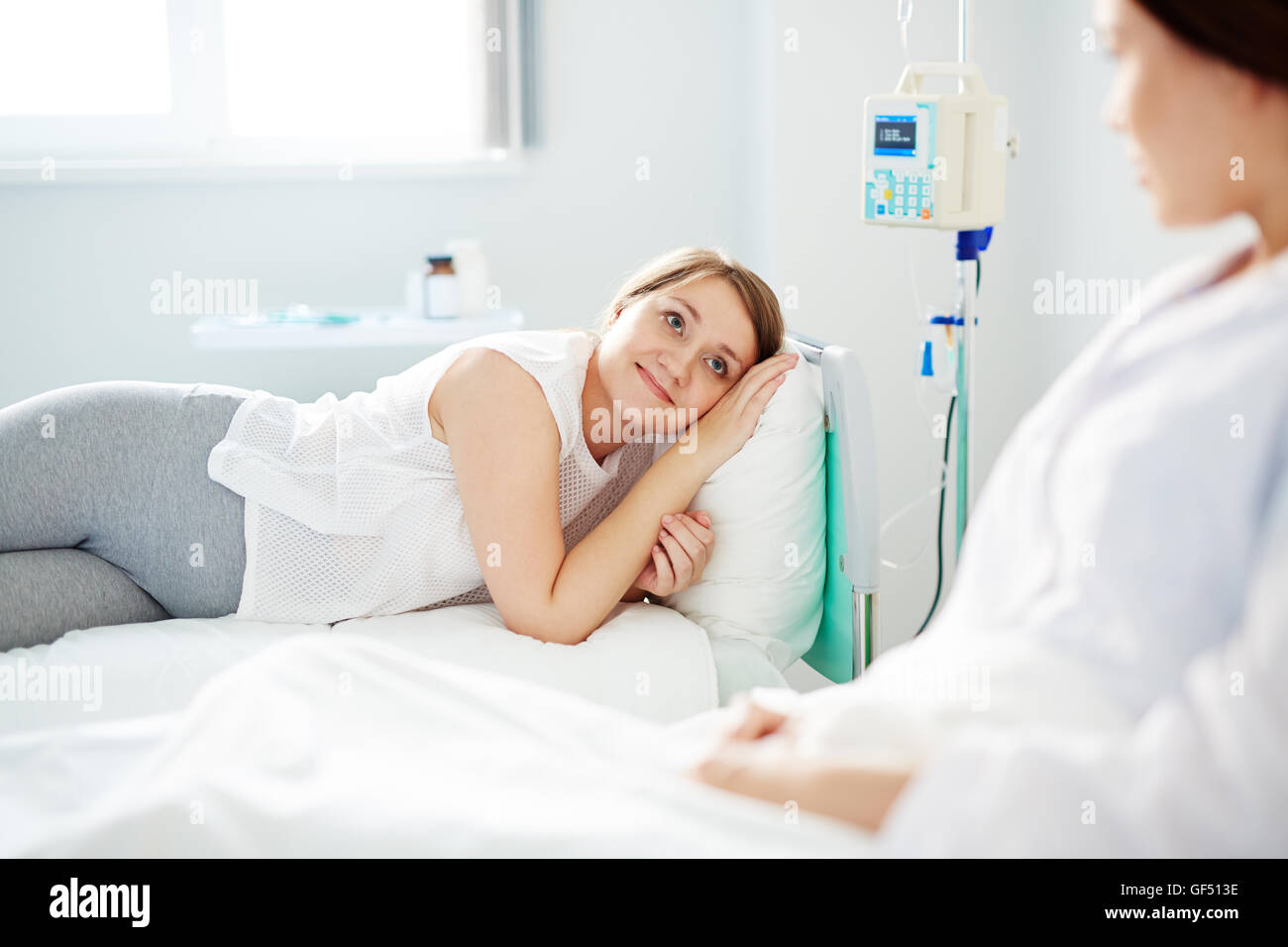 Young woman lying bed in hospital bed hi-res stock photography and ...
