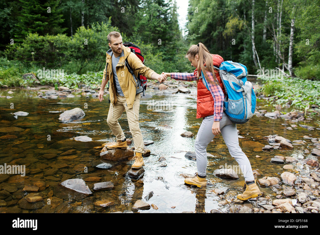 Man helping woman crossing hi-res stock photography and images - Alamy