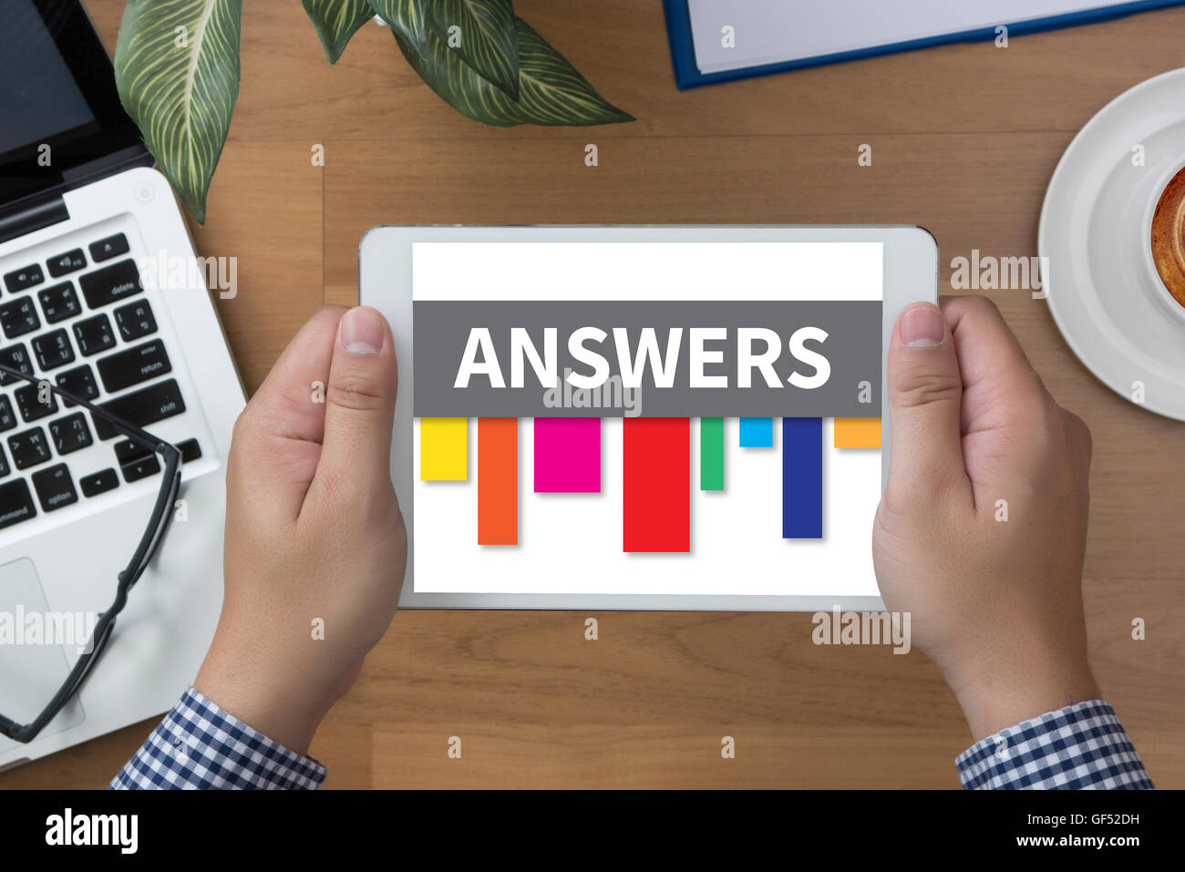 ANSWERS man hand Tablet and coffee cup Stock Photo - Alamy