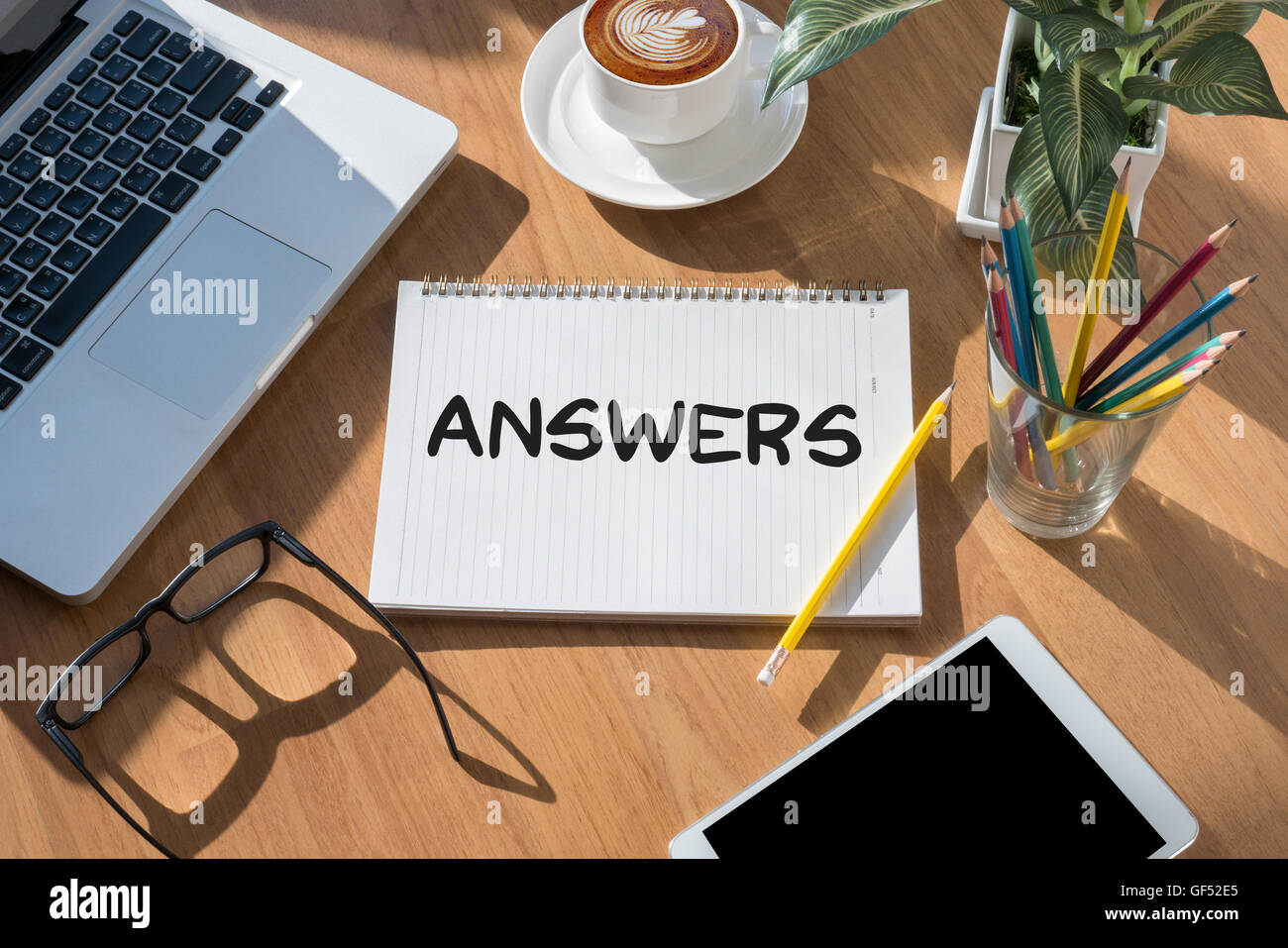 ANSWERS open book on table and coffee Business Stock Photo - Alamy