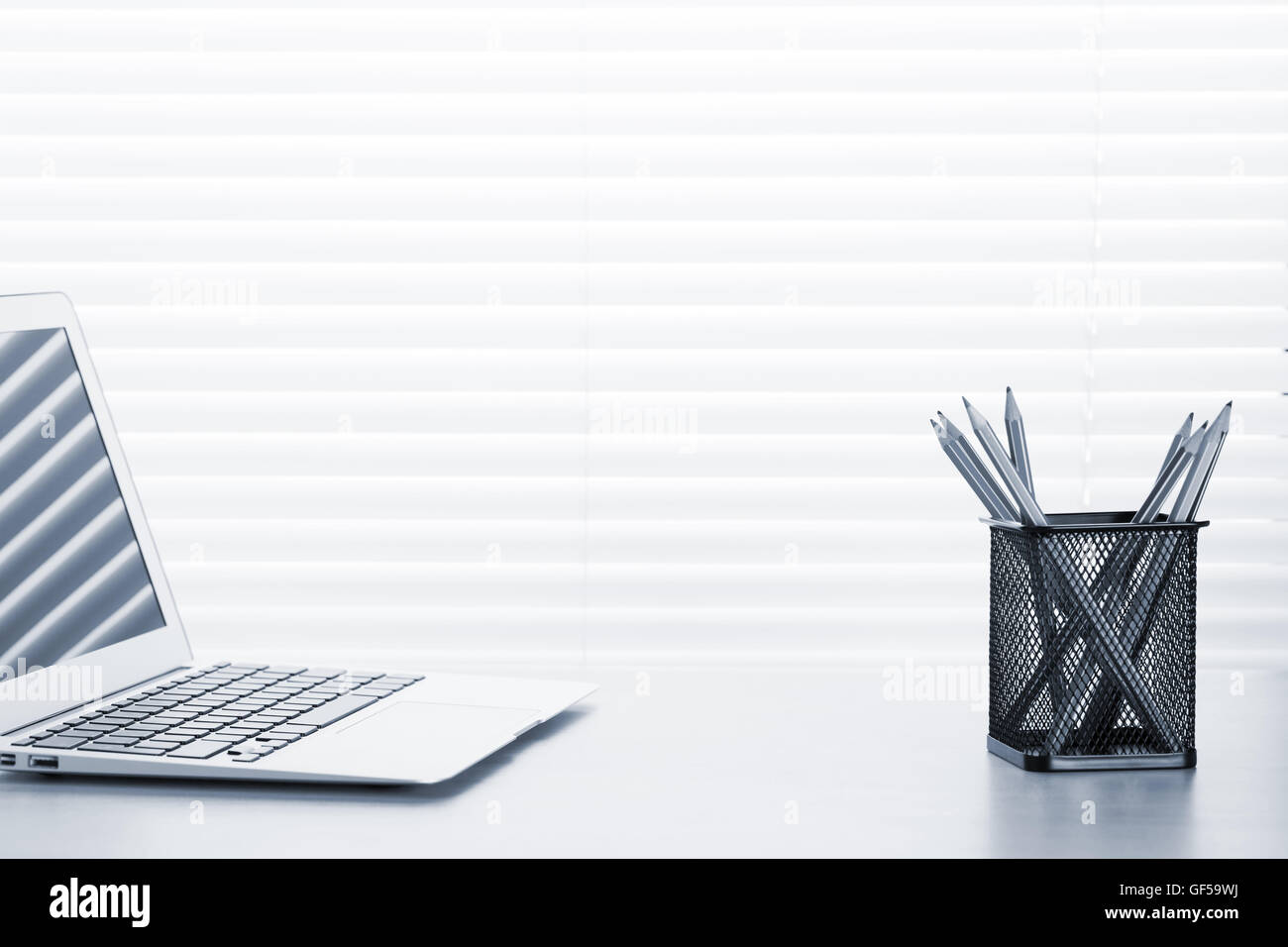 Office workplace with laptop and pencils on desk table in front of ...
