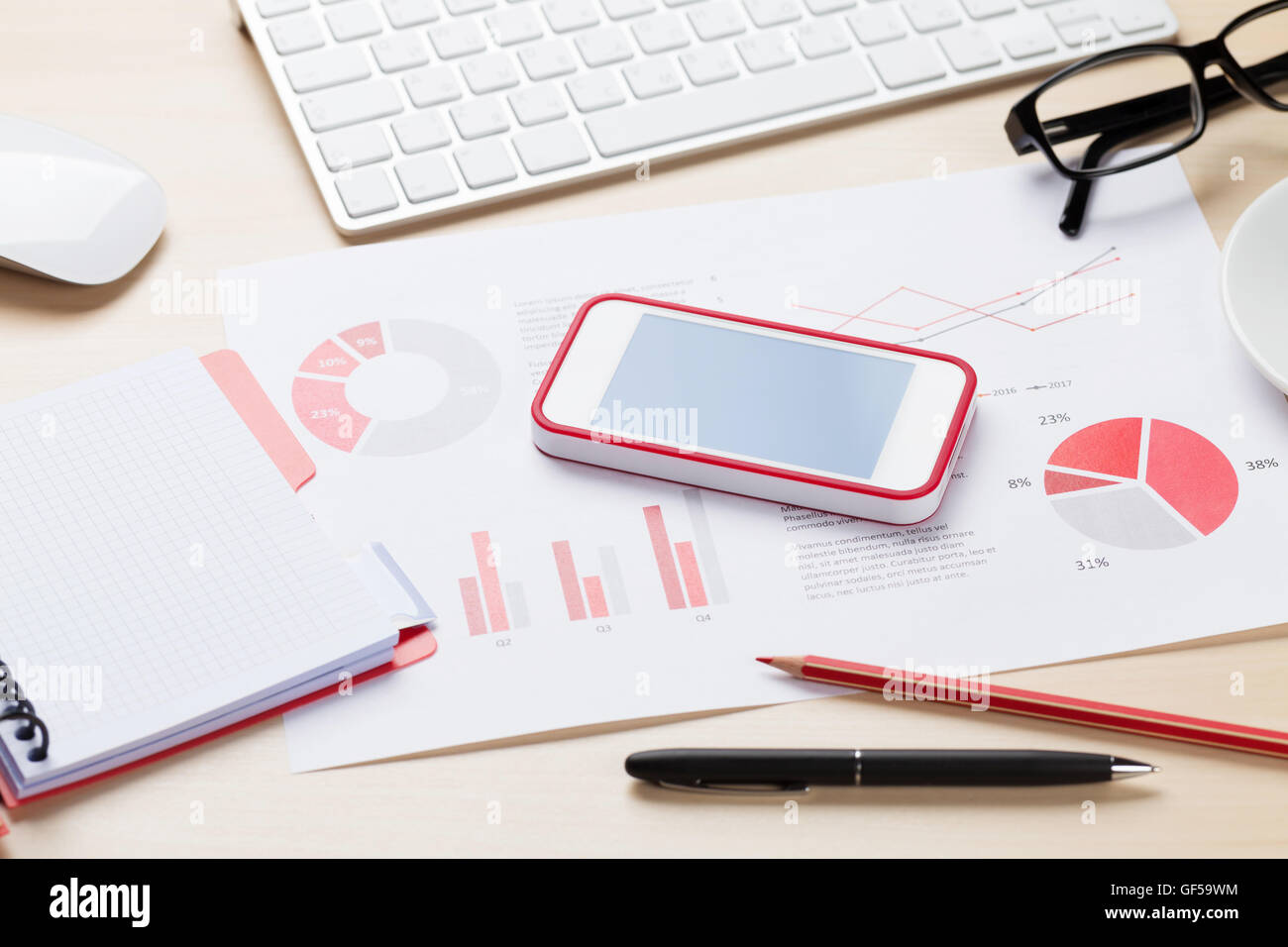 Office desk workplace with smart phone, charts and notepad on wooden ...