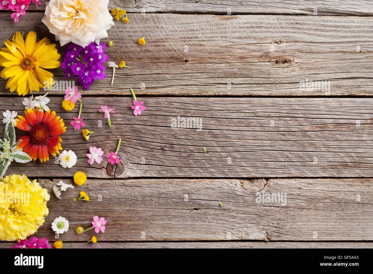 Garden flowers over wooden table background. Backdrop with copy space ...