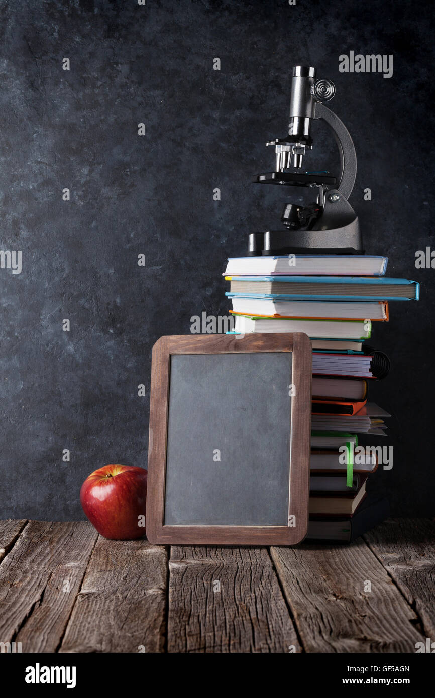 Books and apple in front of classroom chalk board. Back to school ...
