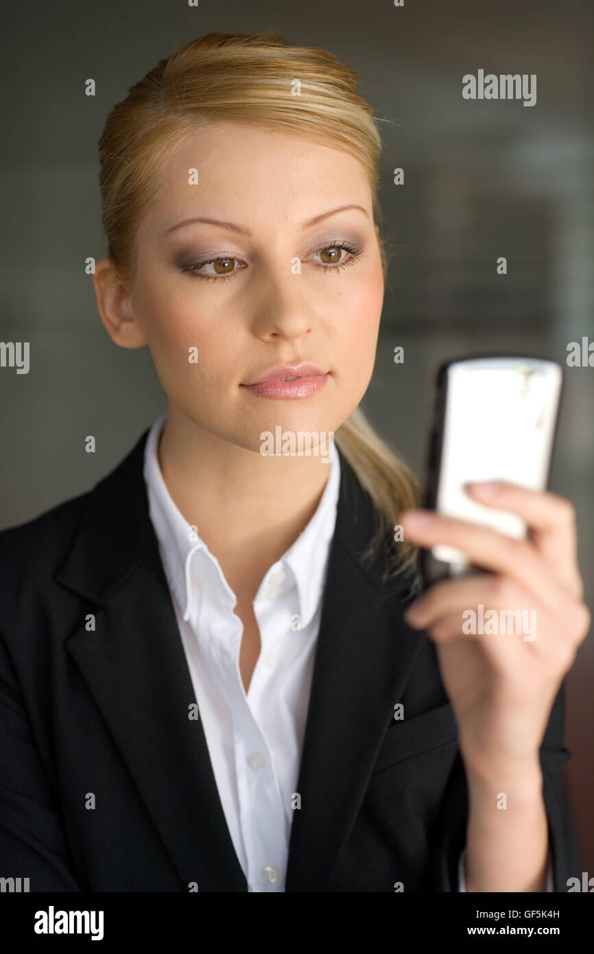 A female executive sending an SMS Stock Photo - Alamy