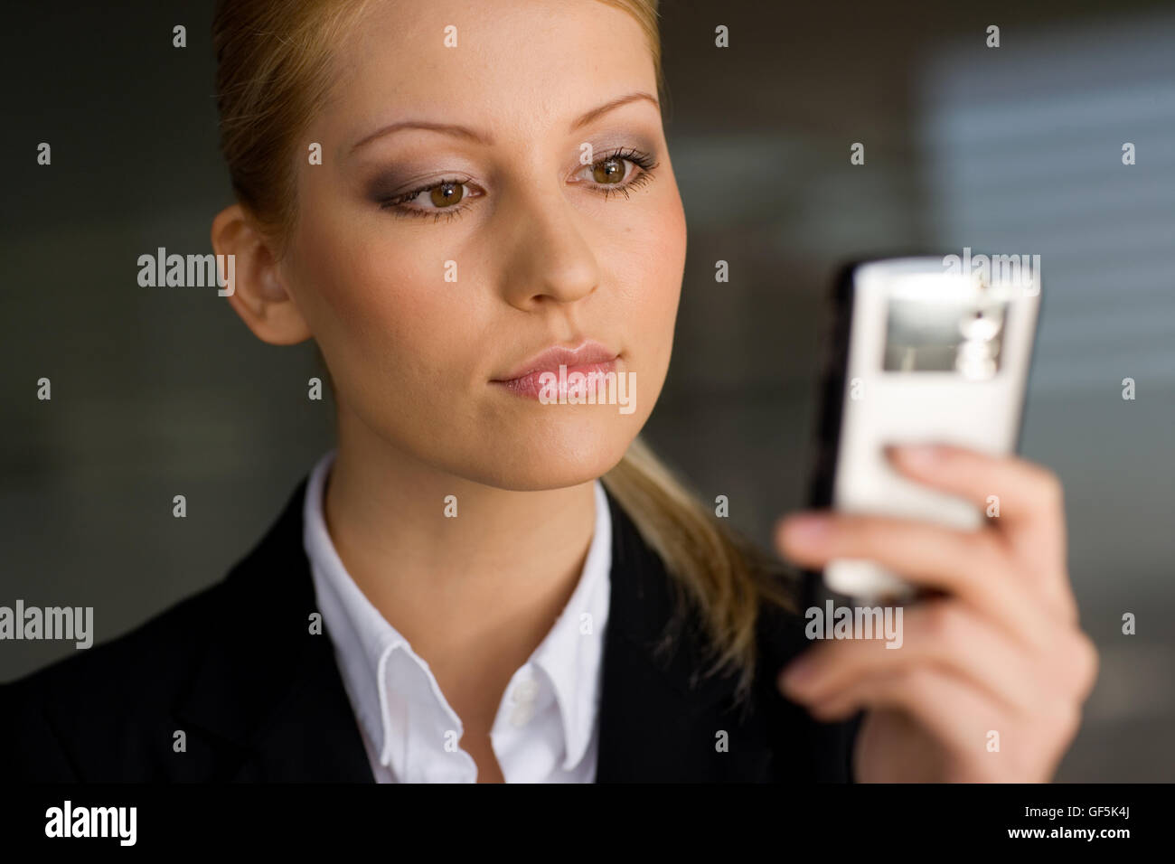 A female executive sending an SMS Stock Photo - Alamy