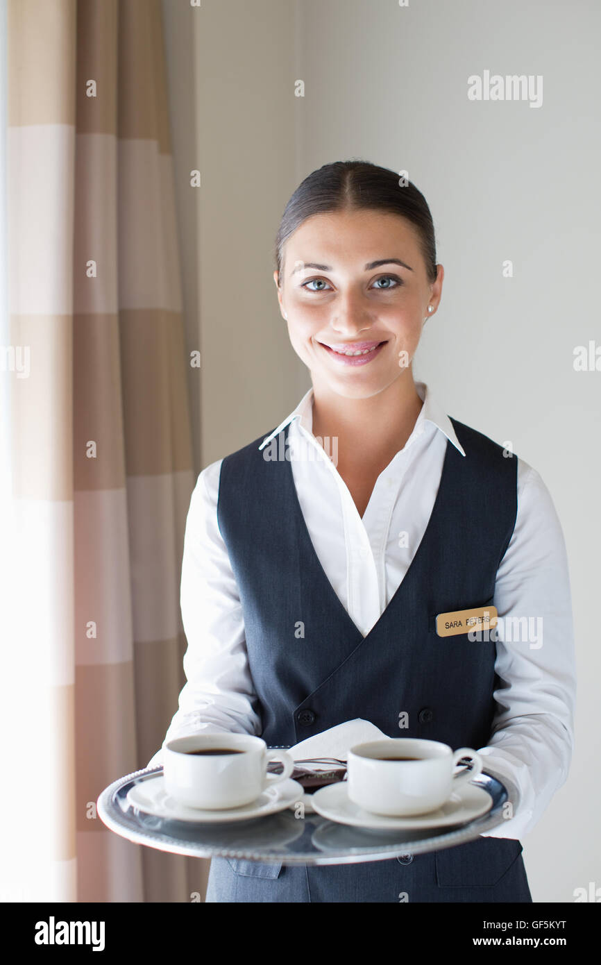 Maid holding breakfast tray in hotel room Stock Photo - Alamy