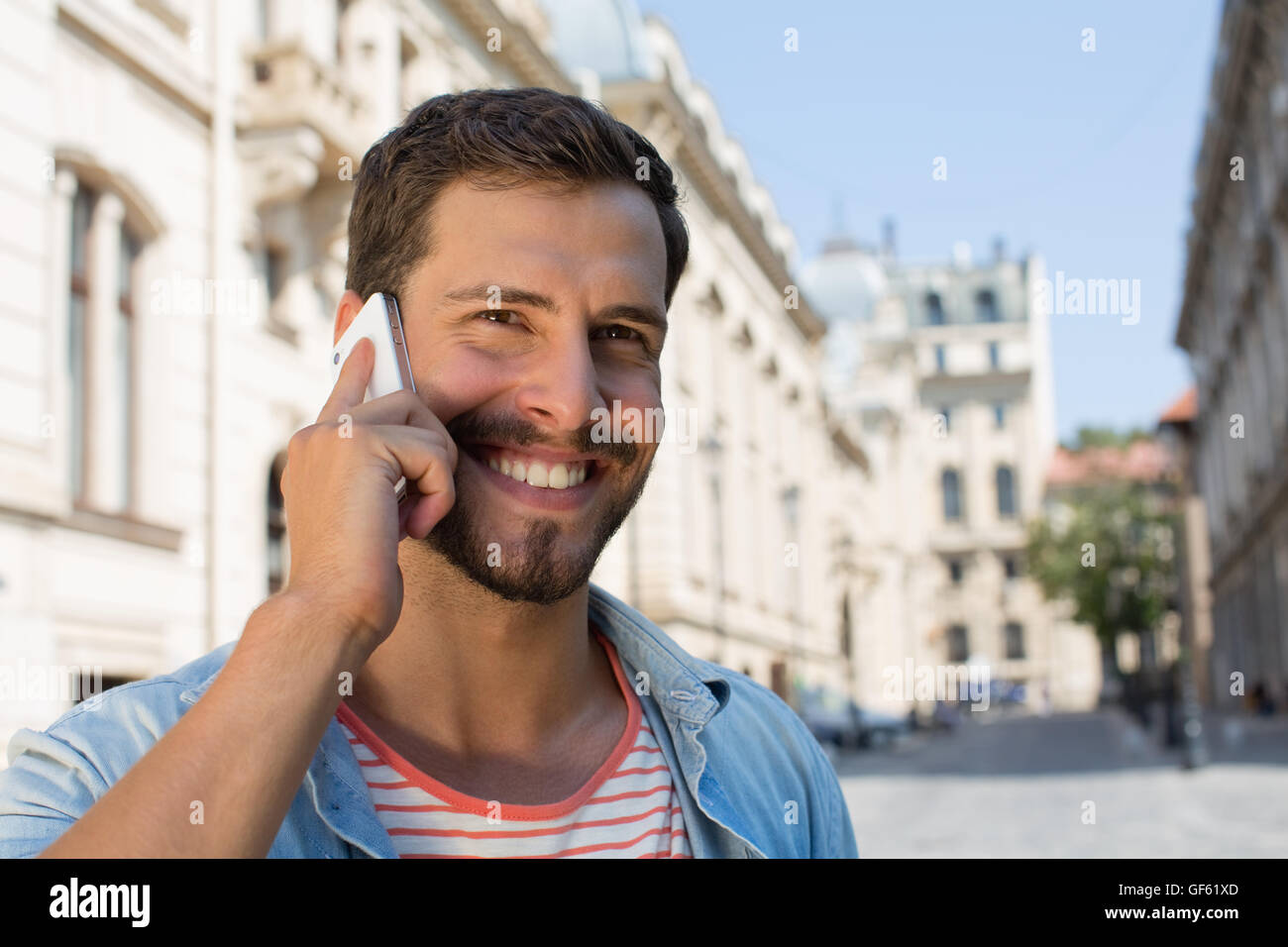 Young man talking on mobile phone Stock Photo - Alamy