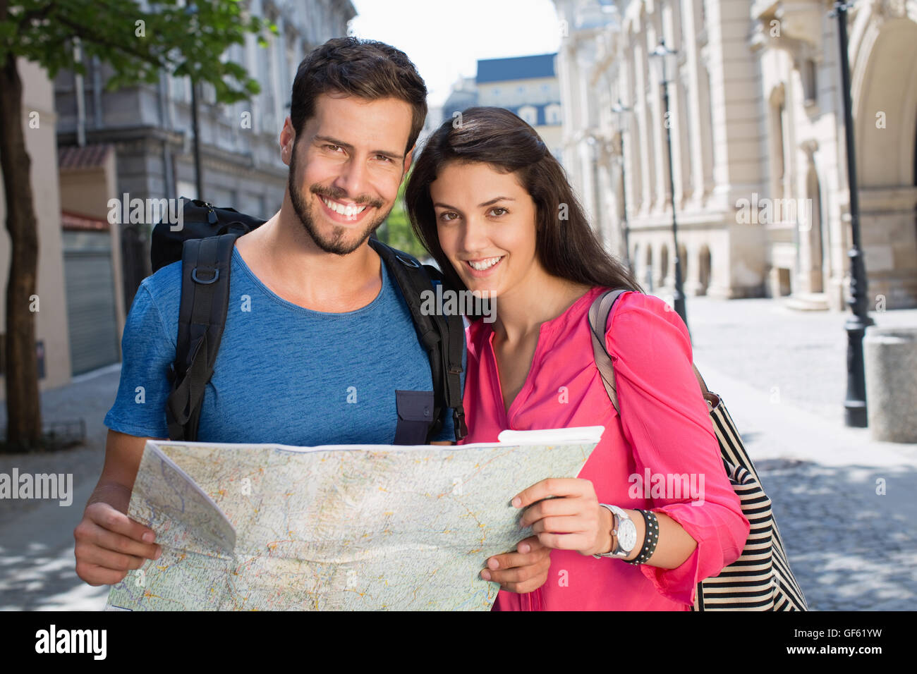 Portrait of young couple holding map Stock Photo - Alamy