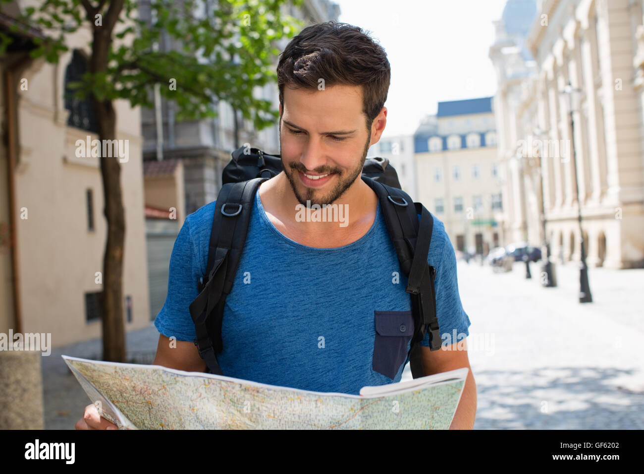 Young man reading map Stock Photo - Alamy