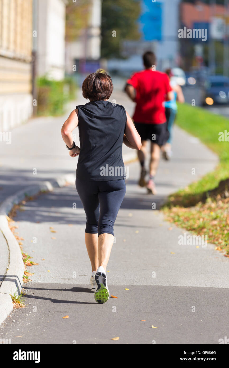 Group of people running Stock Photo - Alamy