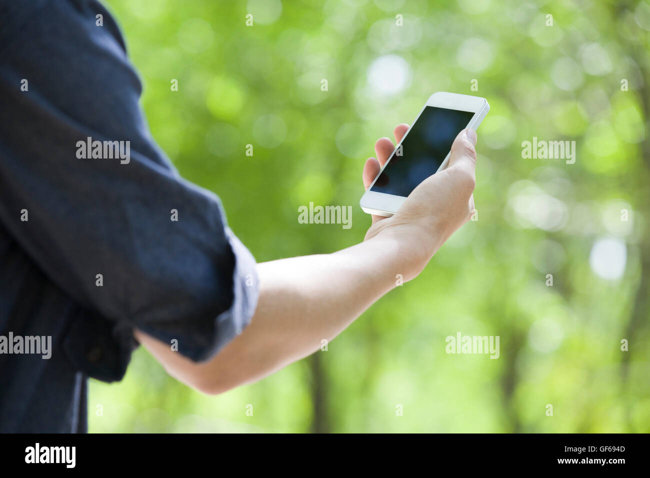 Young Chinese man using smart phone Stock Photo - Alamy