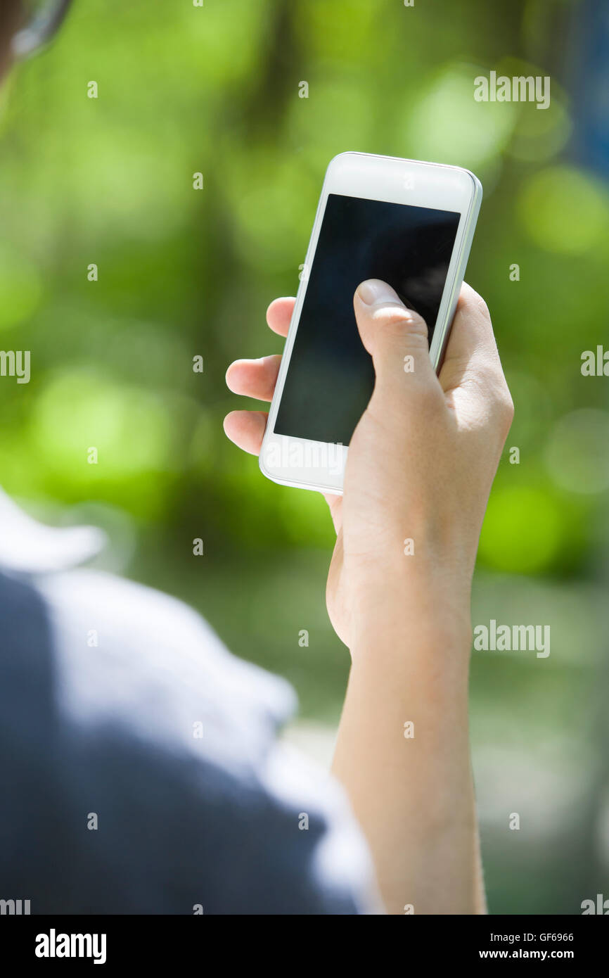 Young Chinese man using smart phone Stock Photo - Alamy