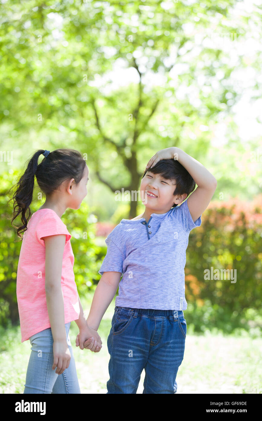 Happy Chinese children playing in woods Stock Photo - Alamy