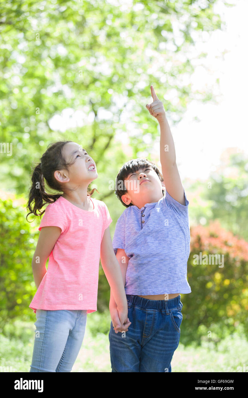 Happy Chinese children playing in woods Stock Photo - Alamy