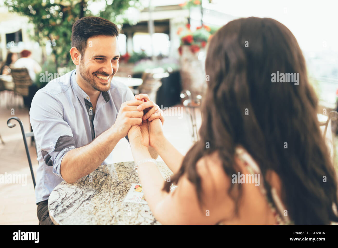 Romantic couple bonding in restaurant outdoors Stock Photo - Alamy