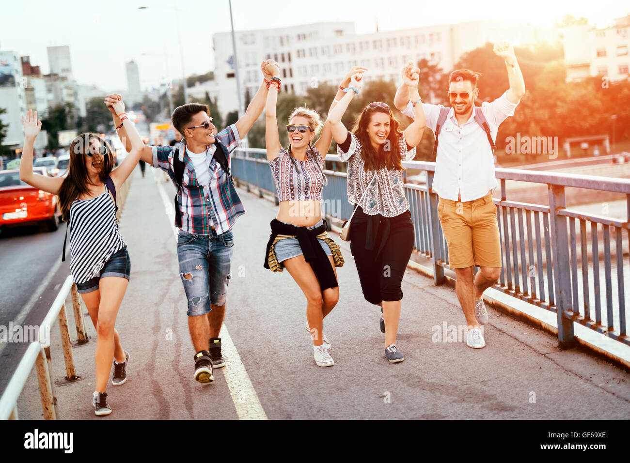 Happy young people hanging out and going to a festival together Stock ...