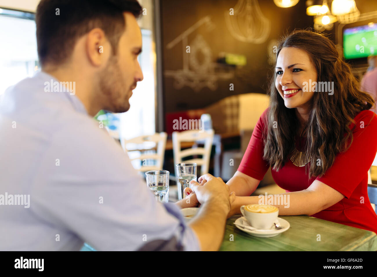 Romantic couple having a coffee in cafe Stock Photo - Alamy