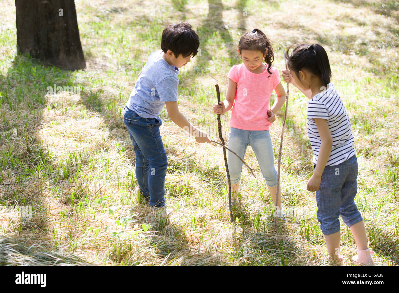 Happy Chinese children playing in woods Stock Photo - Alamy