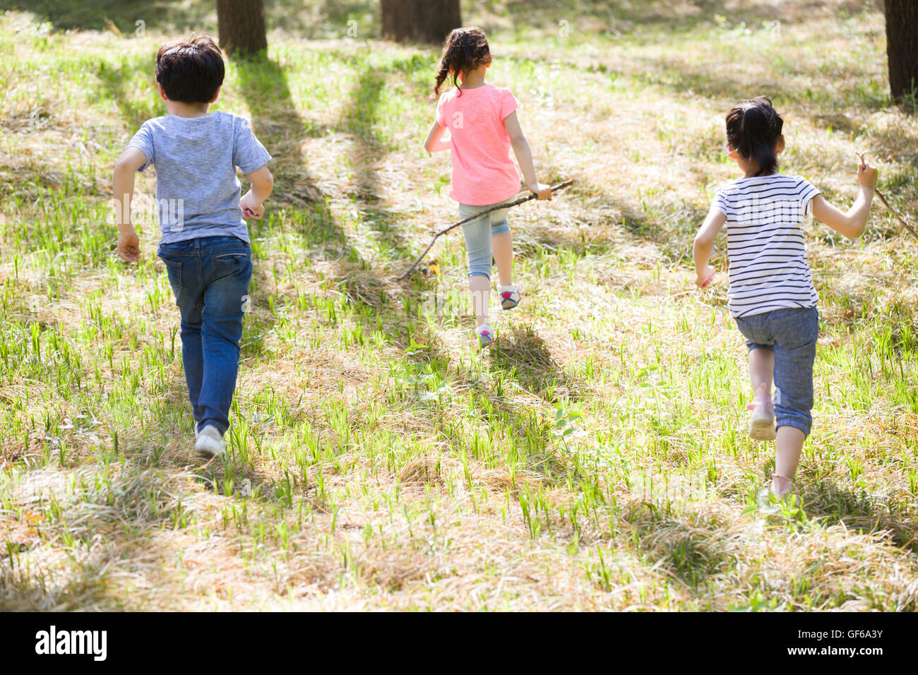 Happy Chinese children playing in woods Stock Photo - Alamy