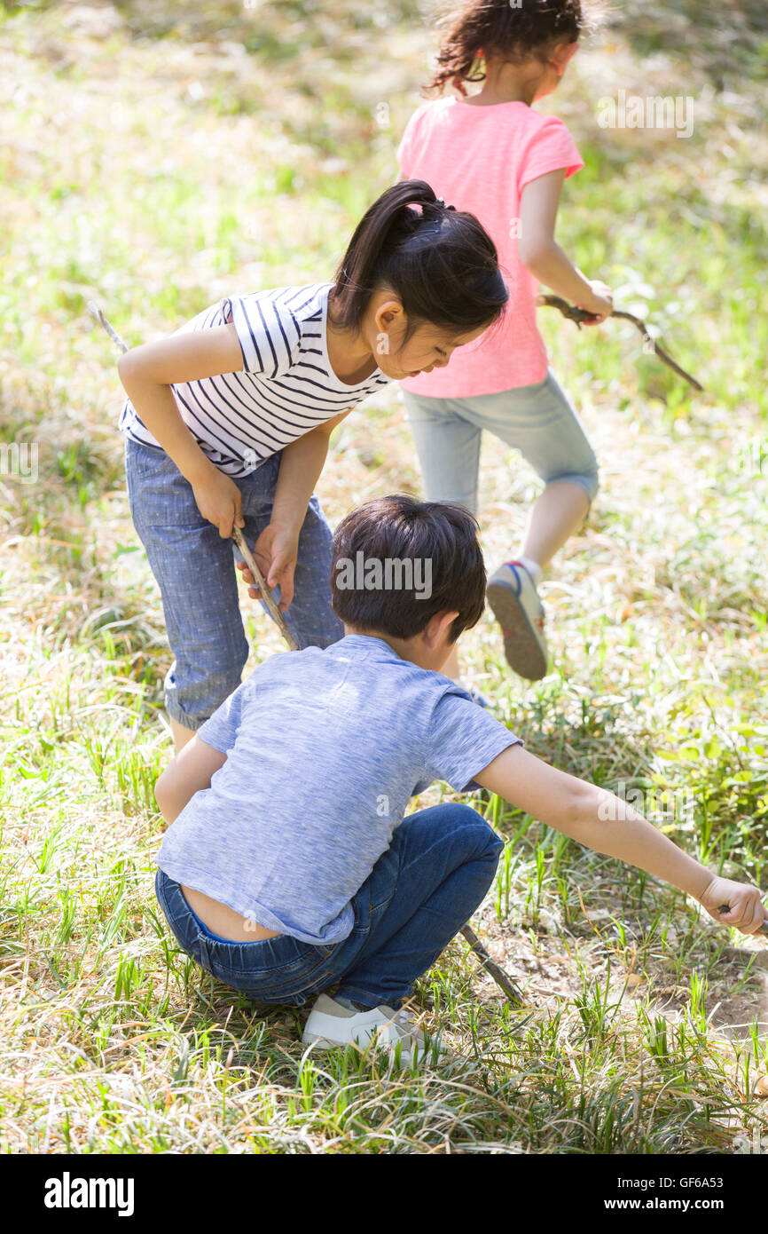 Happy Chinese children playing in woods Stock Photo - Alamy