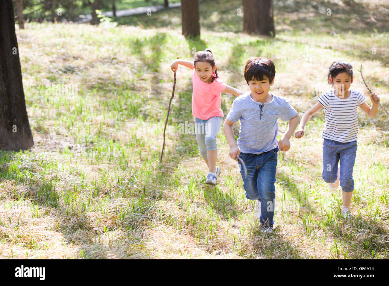 Happy Chinese children playing in woods Stock Photo - Alamy