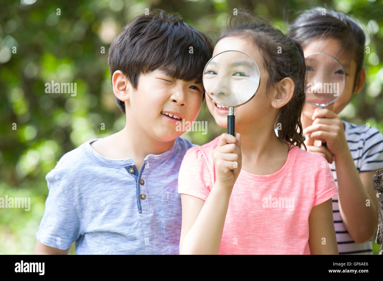 Happy Chinese children playing in woods Stock Photo - Alamy