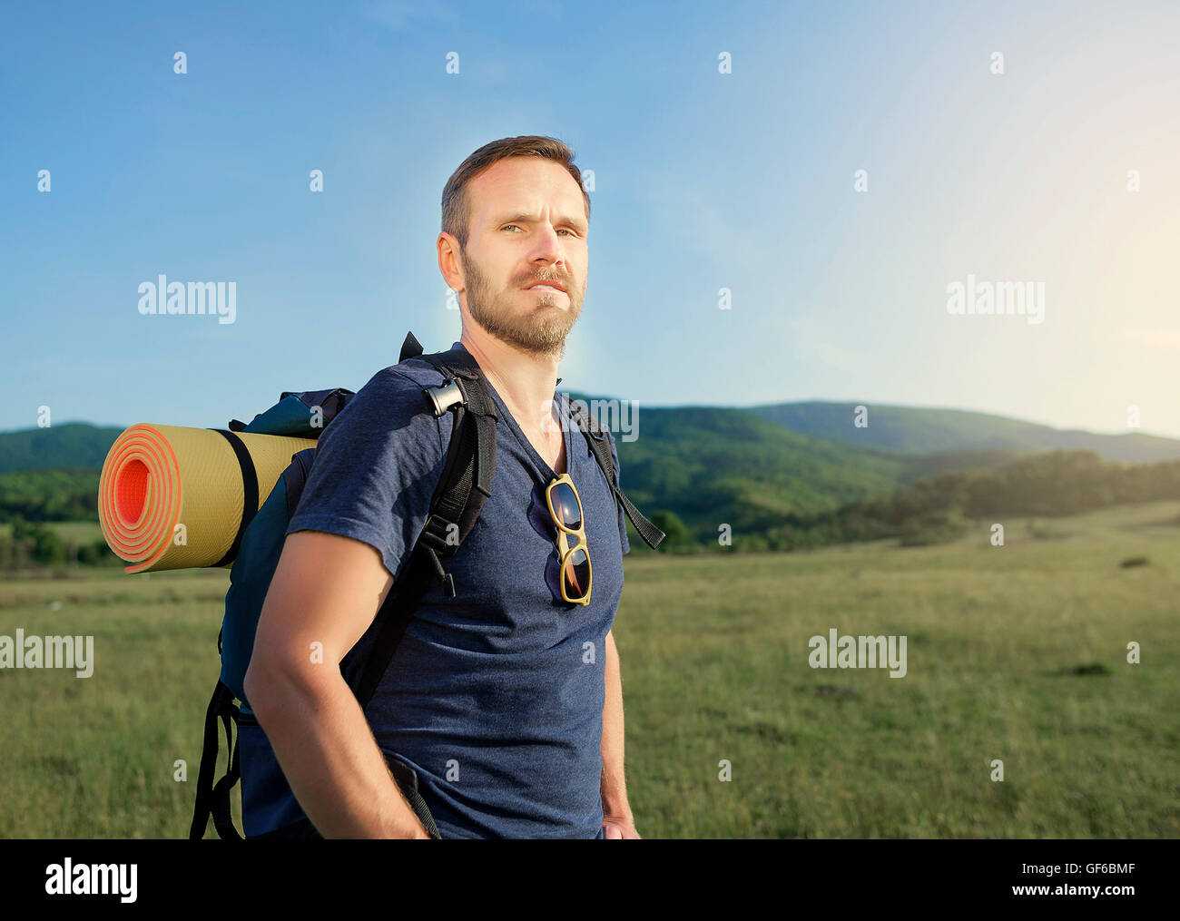 Attractive male hiker on hillside on sunset Stock Photo - Alamy
