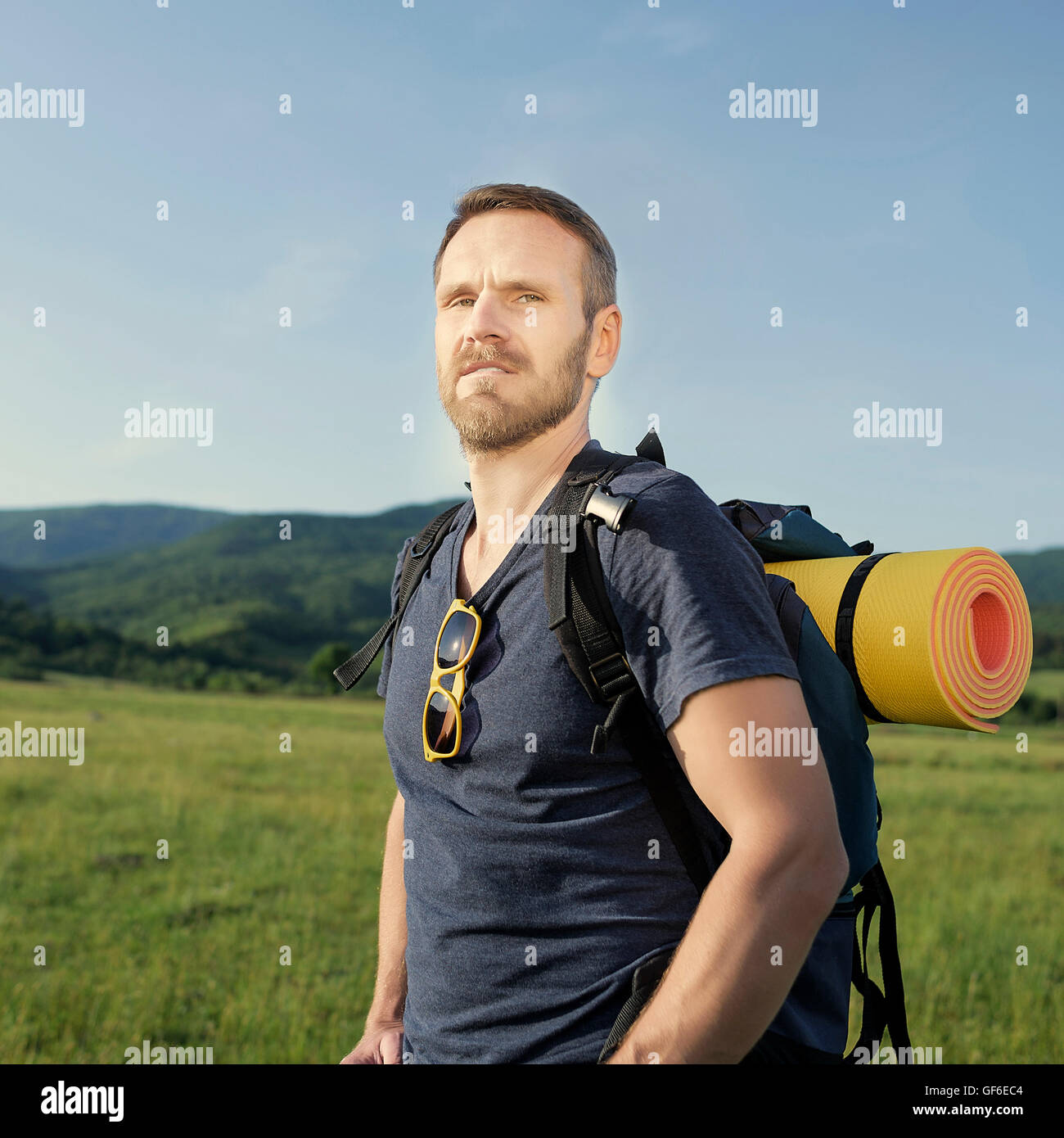Attractive male hiker on hillside on sunset Stock Photo - Alamy