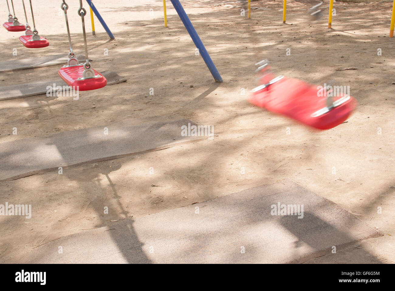 Red swing in the park Stock Photo - Alamy