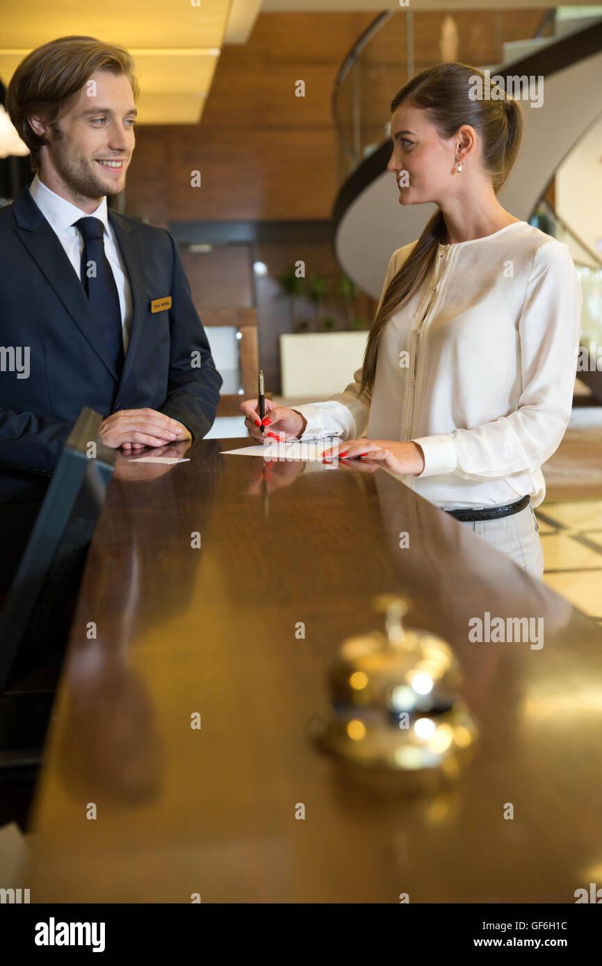 Checking out hotel reception hi-res stock photography and images - Alamy
