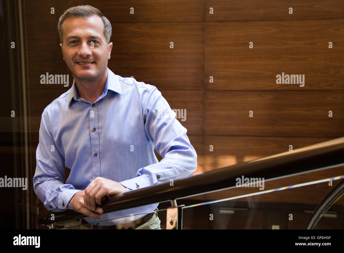 Portrait of man standing in hotel Stock Photo - Alamy