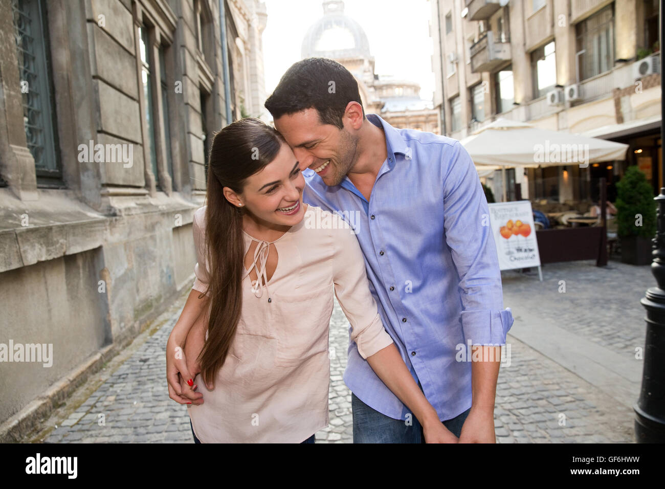 Man and woman walking on street Stock Photo - Alamy
