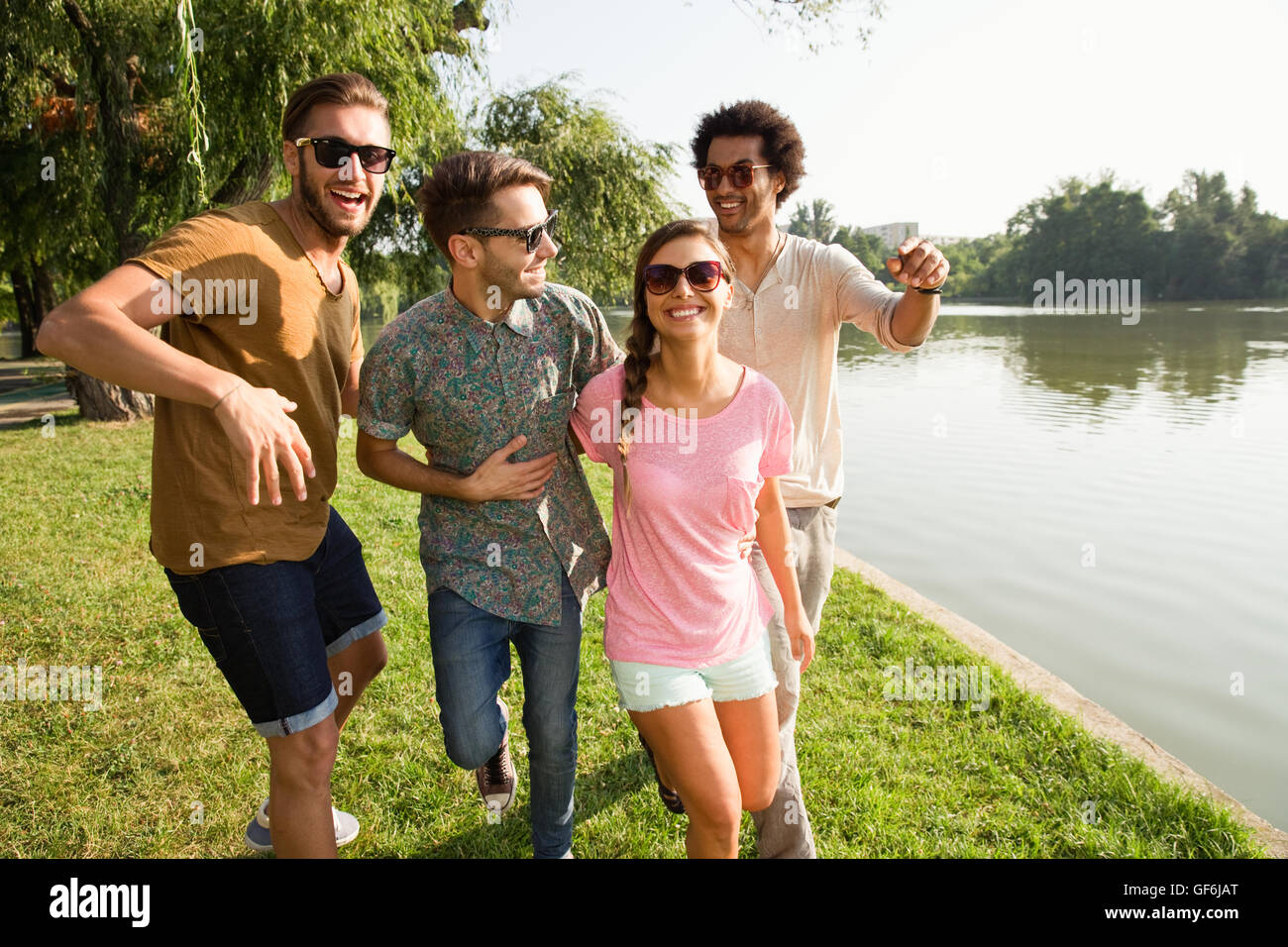 Friends having fun at riverbank Stock Photo - Alamy