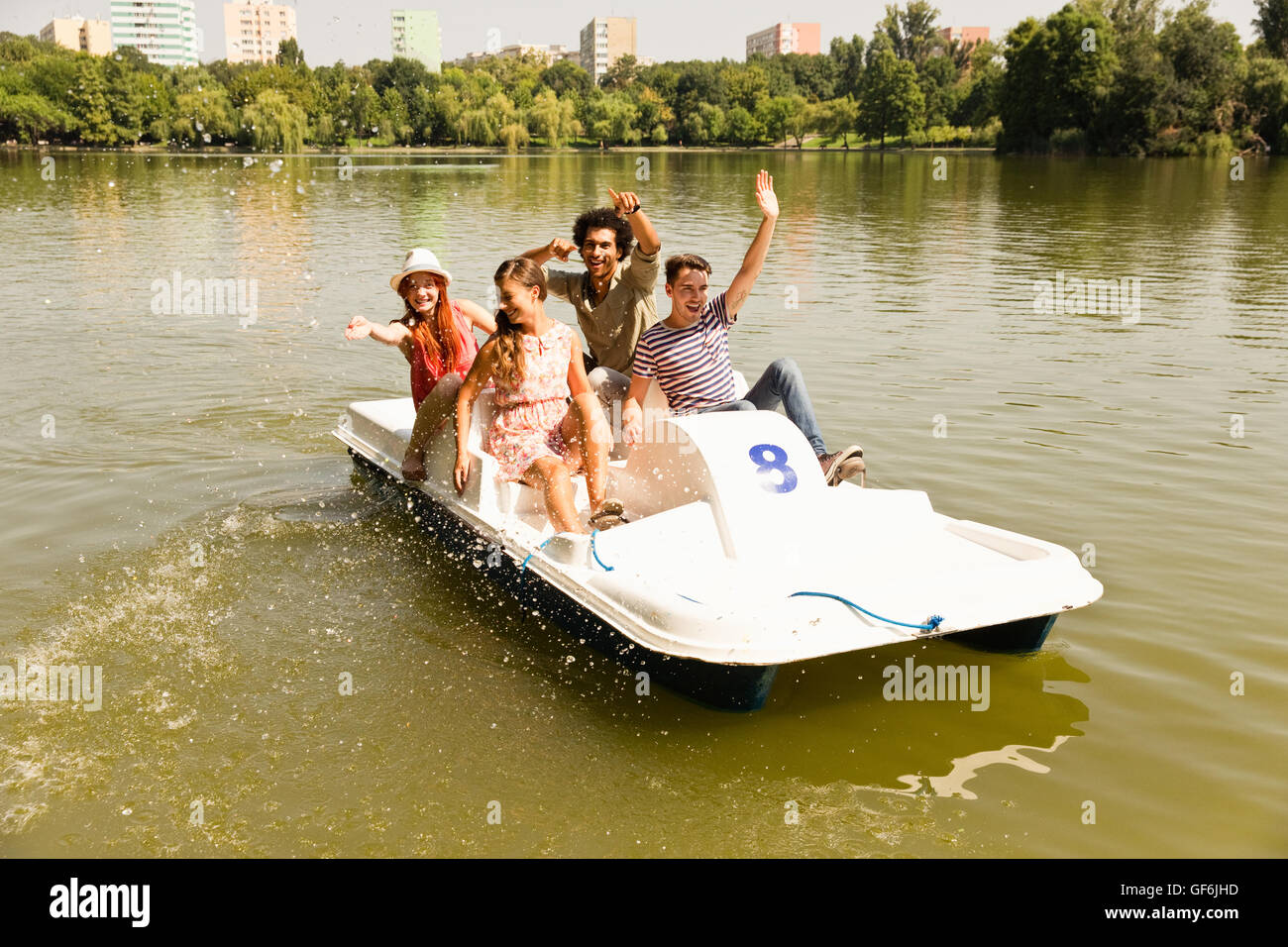 Friends paddling boat in river and smiling Stock Photo - Alamy