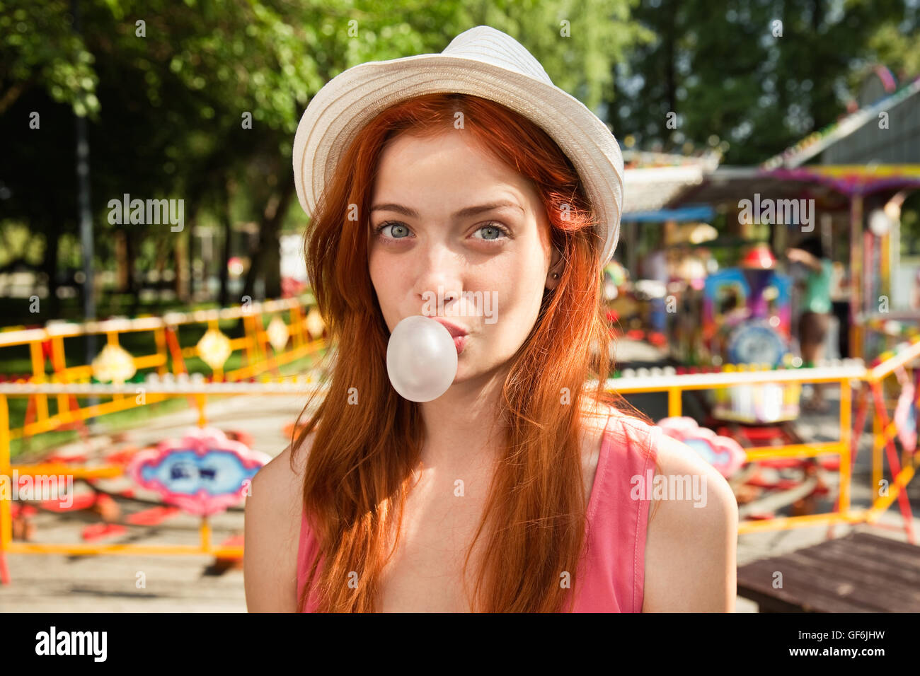 Portrait of young woman blowing bubble gum Stock Photo - Alamy