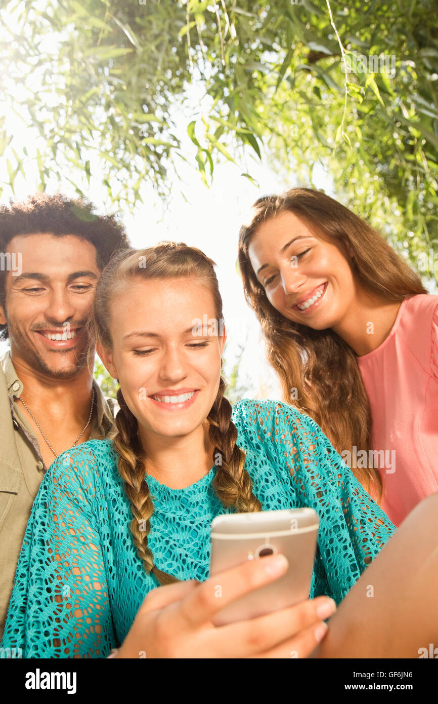 Friends using mobile phone Stock Photo - Alamy