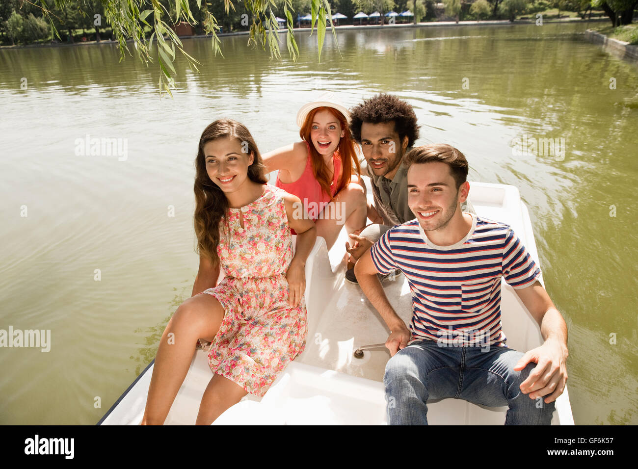 Friends paddling boat in river Stock Photo - Alamy
