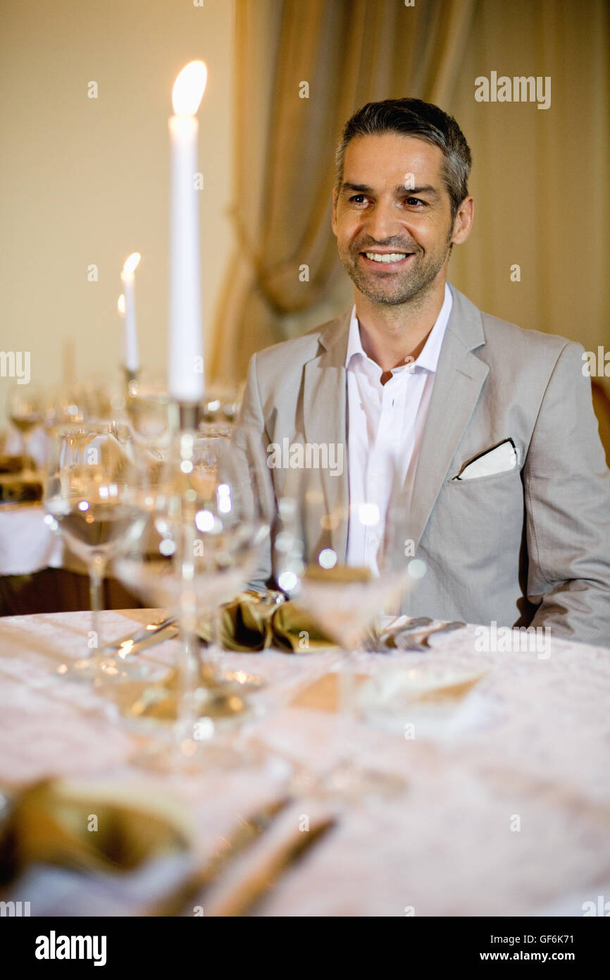Man sitting in restaurant, smiling Stock Photo - Alamy