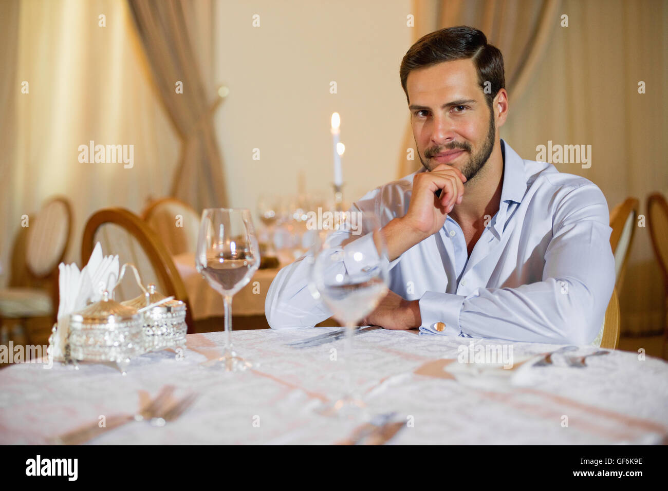 Portrait of man sitting in restaurant Stock Photo - Alamy