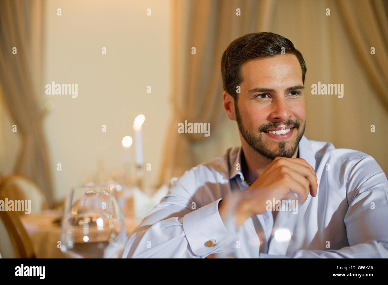 Man sitting in restaurant, smiling Stock Photo - Alamy