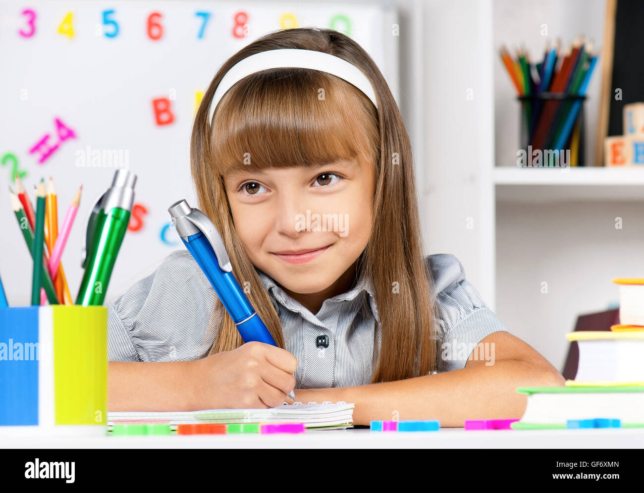 Girl in school at the desk Stock Photo - Alamy
