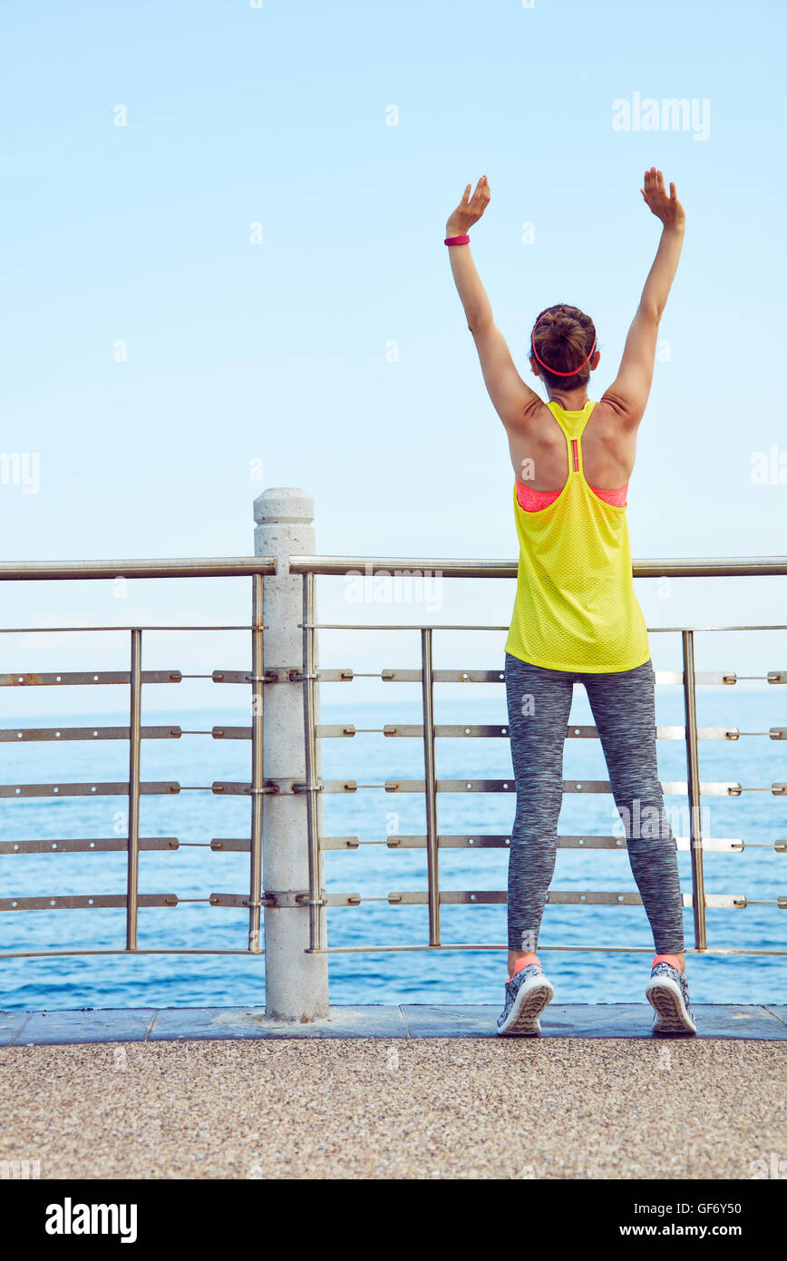 Look Good, Feel great! Seen from behind relaxed young woman in fitness ...