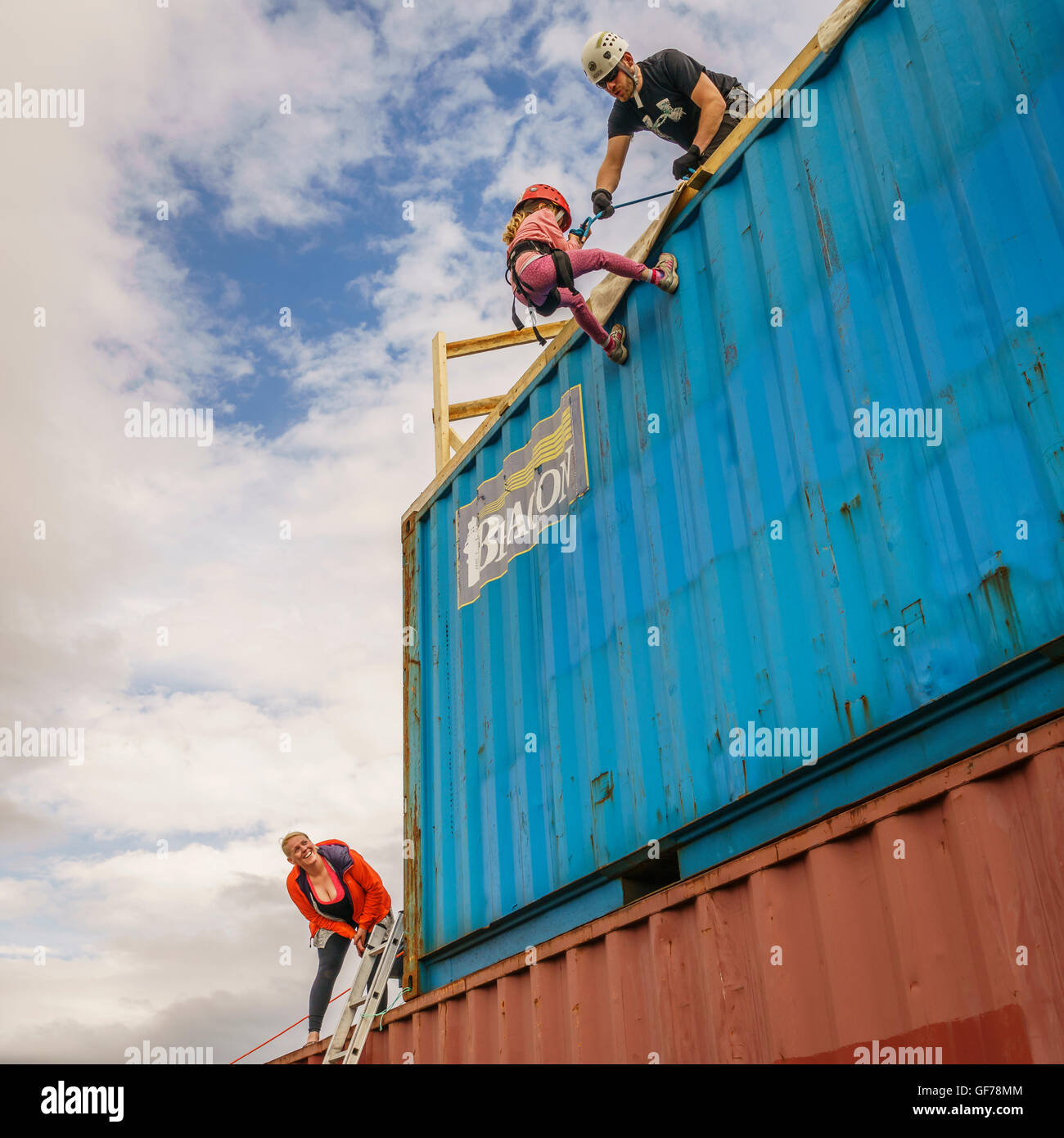 Young girl repelling down shipping containers at The Annual Seaman's ...