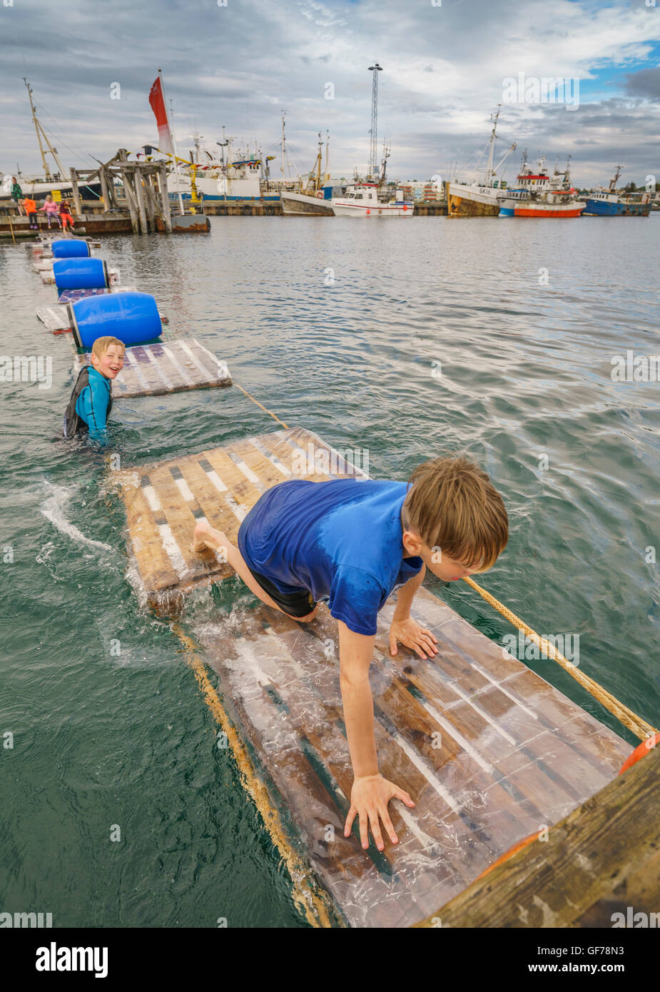 Boys crossing rafts at The Annual Seaman's Festival, Hafnarfjordur ...