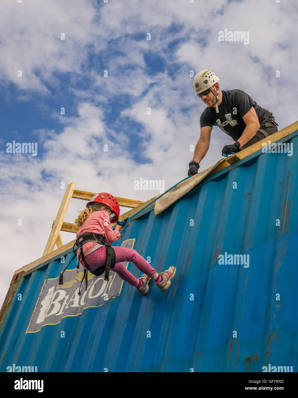 Young girl repelling down shipping containers at The Annual Seaman's ...