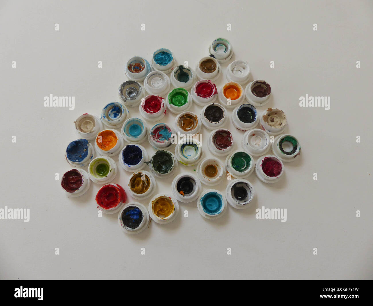 colorful paint caps on white background Stock Photo - Alamy
