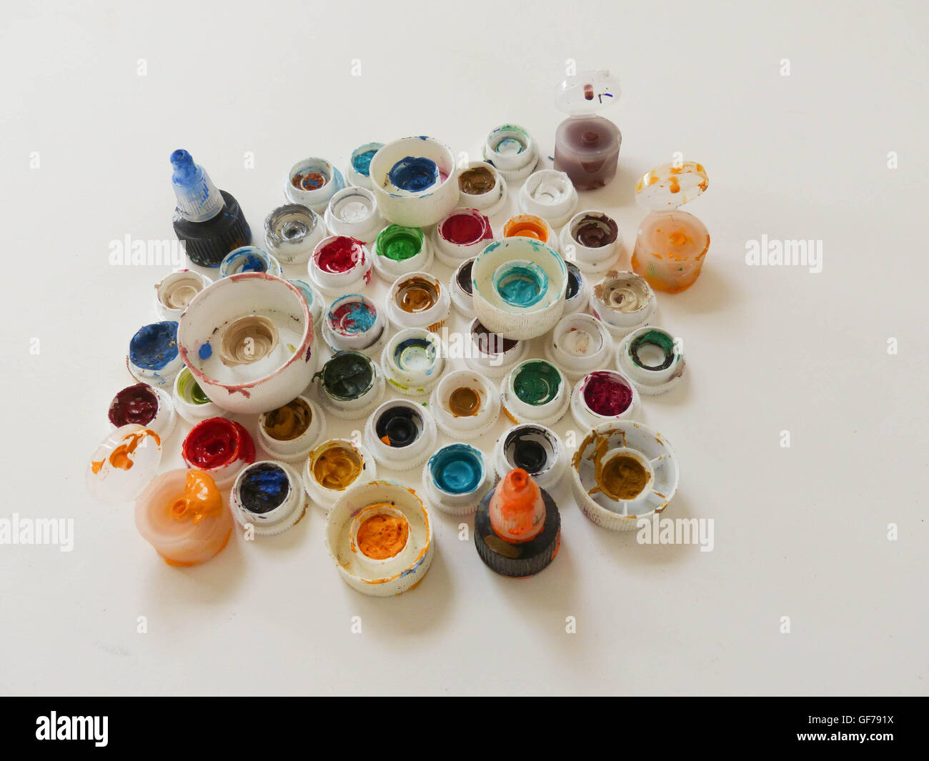 colorful paint caps on white background Stock Photo - Alamy