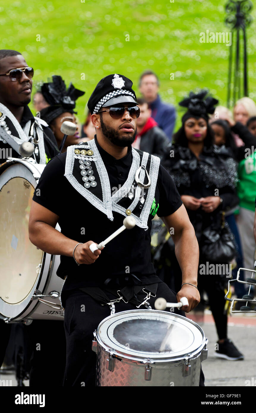 Drum and dance troupe dressed as American police taking part in the ...